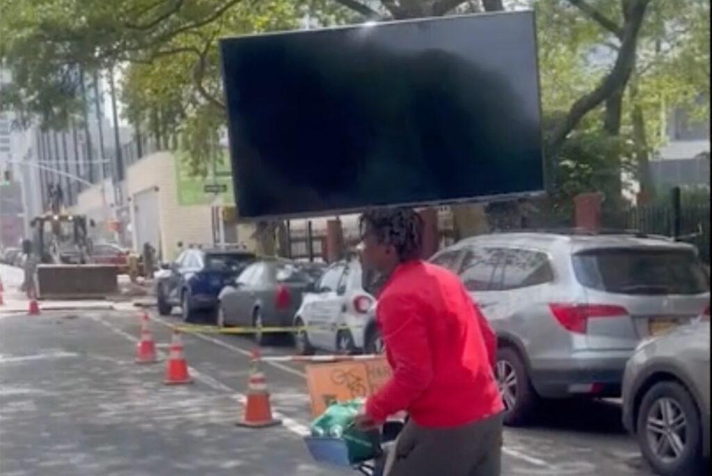 Only In New York! Man Is Seen Balancing A 45-Inch TV On His Head While ...